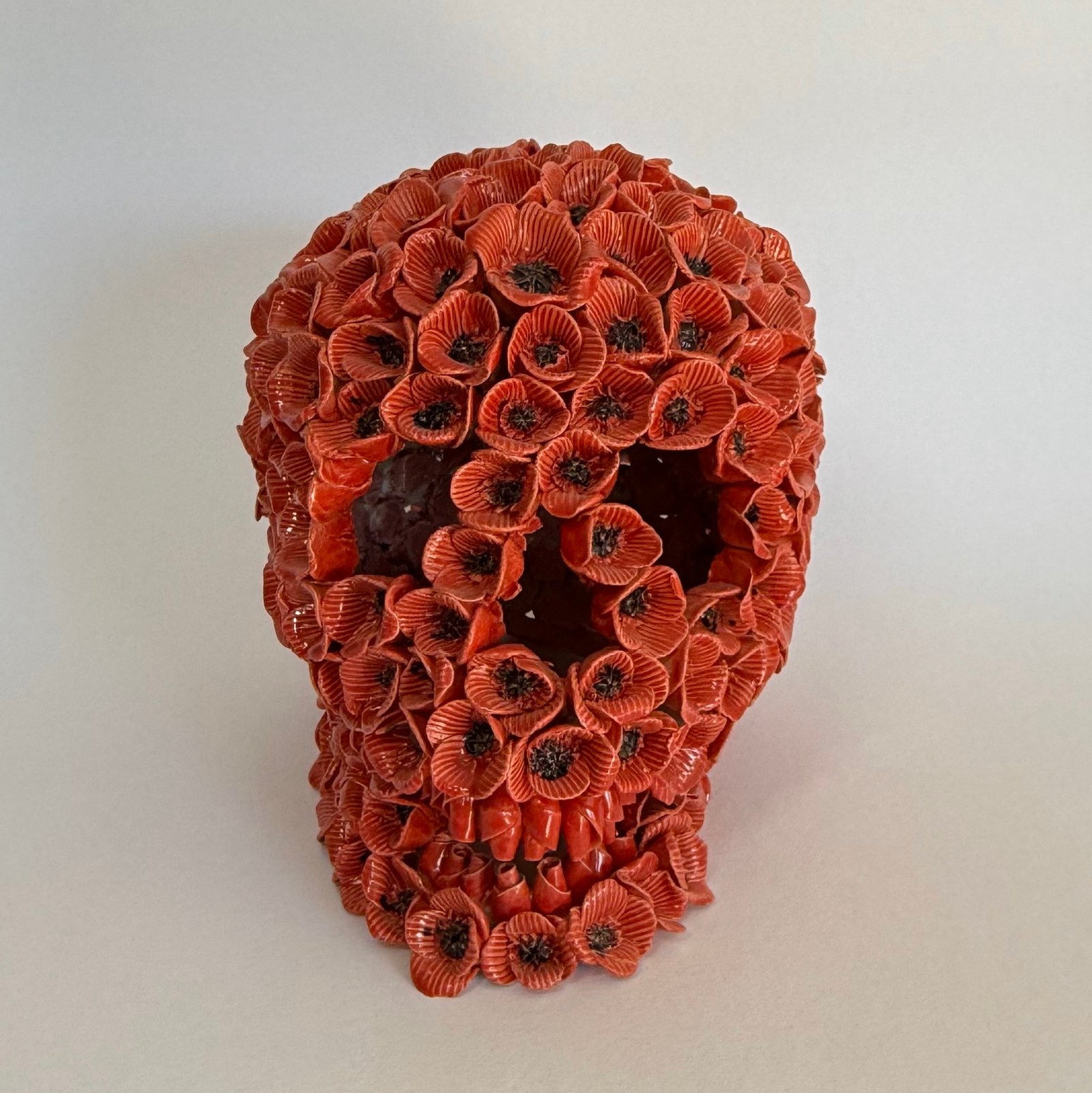 Red Poppy Skull: A Floral Ceramic Skull Sculpture - Carolyn Clayton